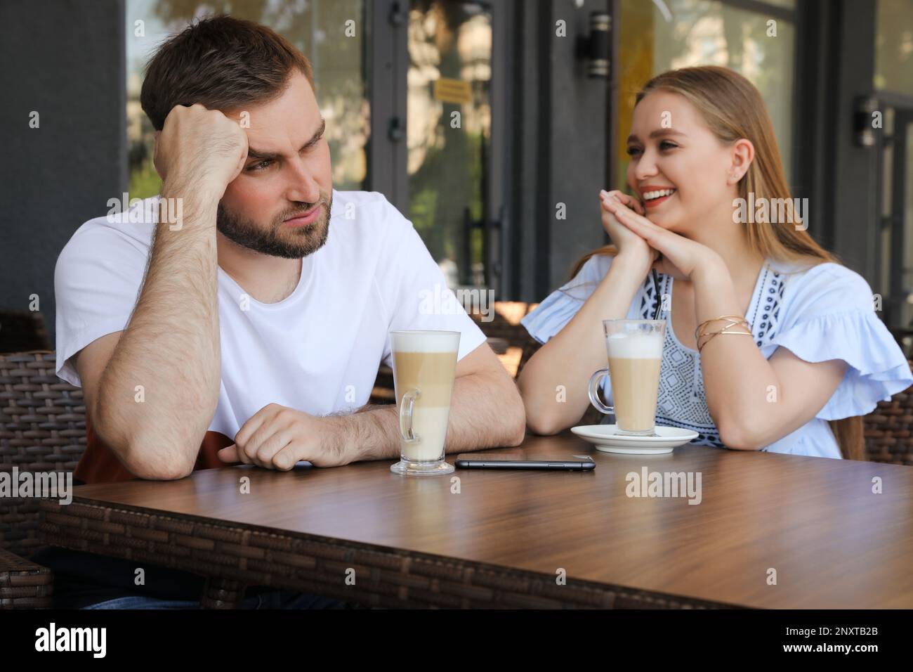 Young man having boring date with talkative girl in outdoor cafe Stock ...