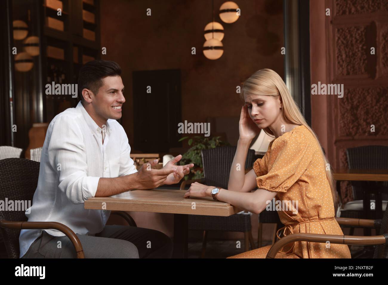 Young woman having boring date with talkative man in outdoor cafe Stock ...