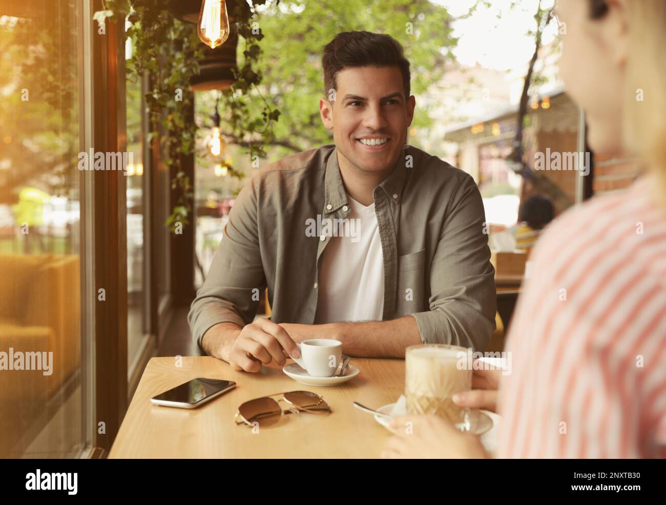 Lovely couple spending time at cafe in morning Stock Photo - Alamy