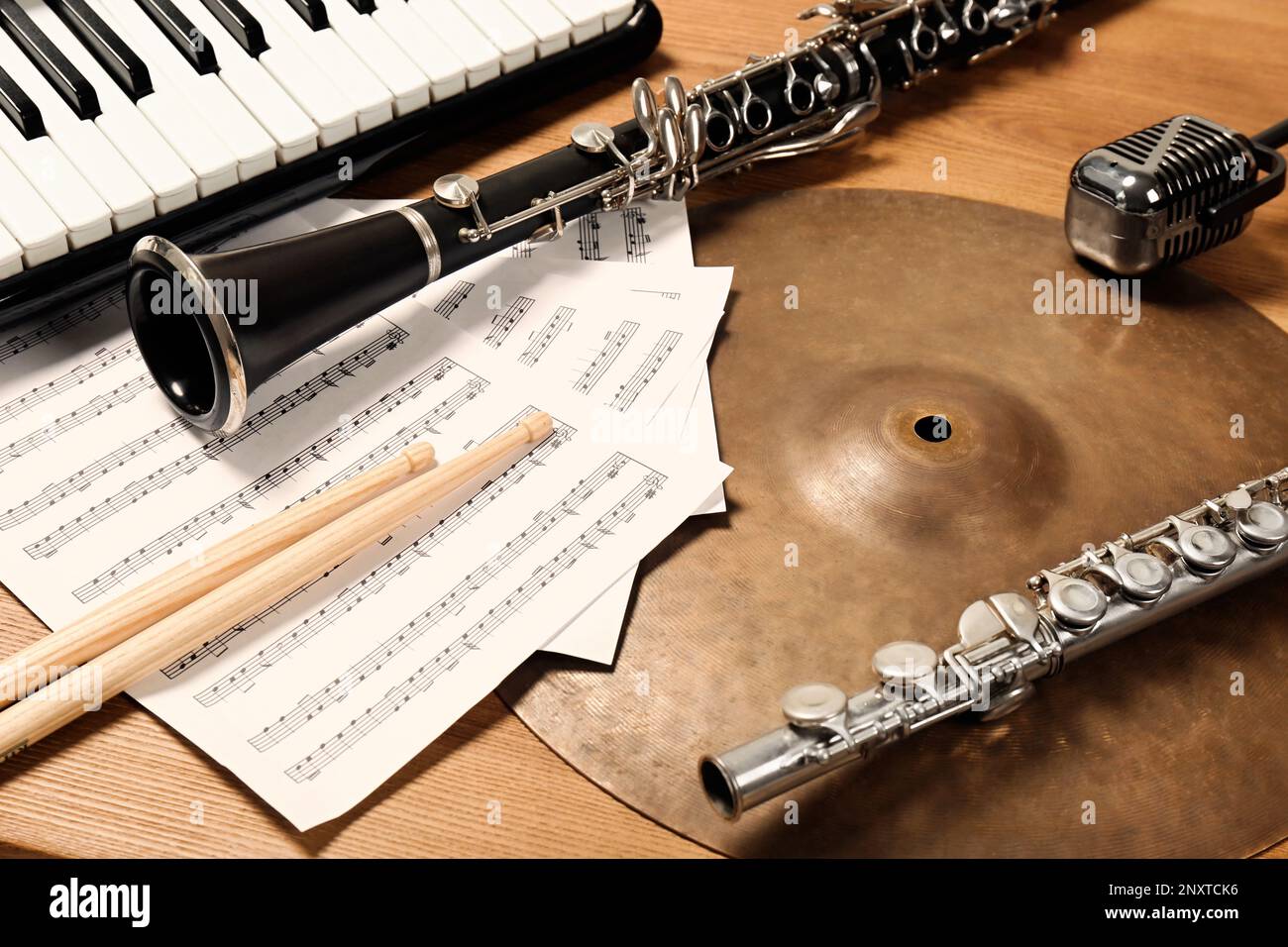 Set of different musical instruments on wooden background, closeup ...