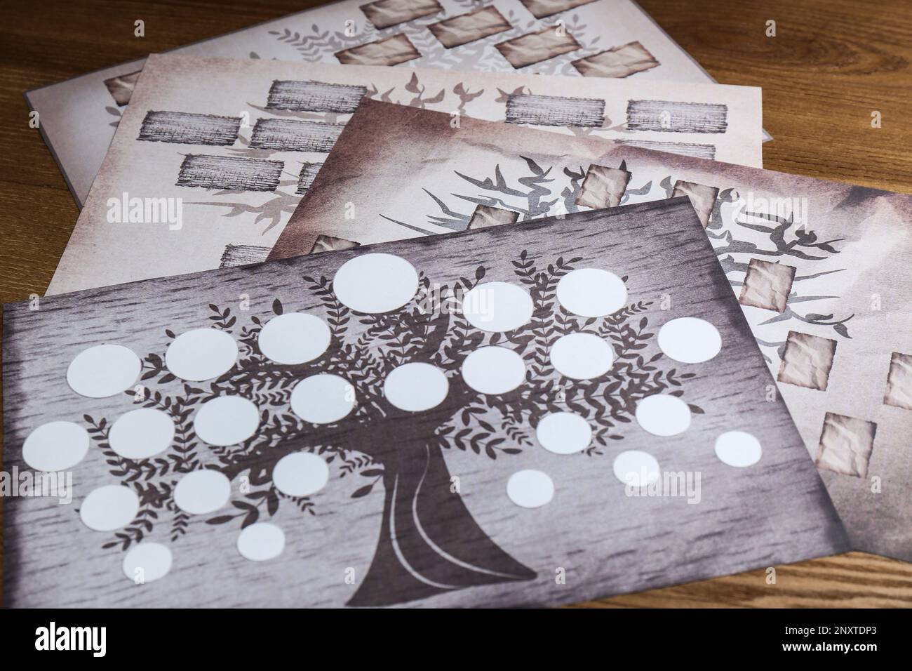 Blank family tree charts on wooden table, closeup Stock Photo - Alamy