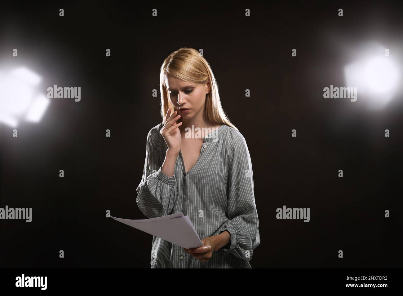 Professional actress reading her script during rehearsal in theatre ...