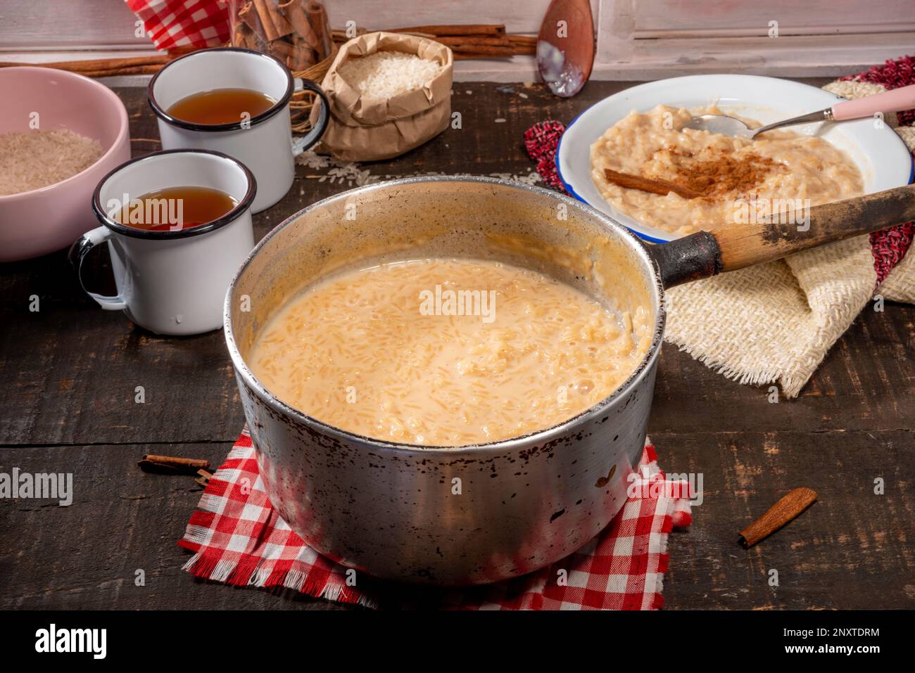 sweet rice served in rustic dish, pot and cups of coffee in the ...