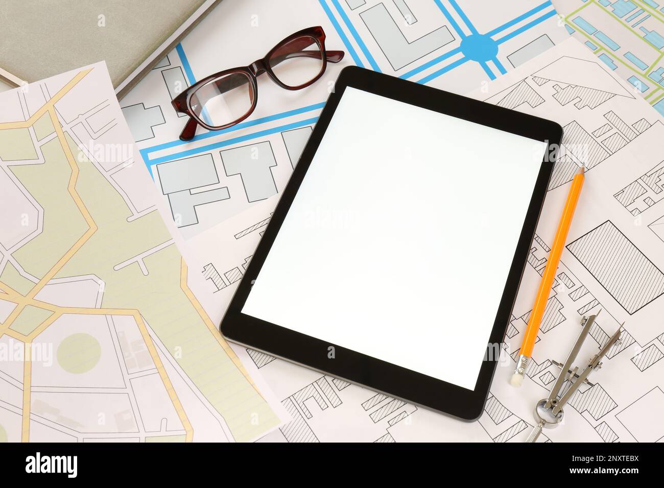 Office stationery, eyeglasses and tablet on cadastral maps of territory ...
