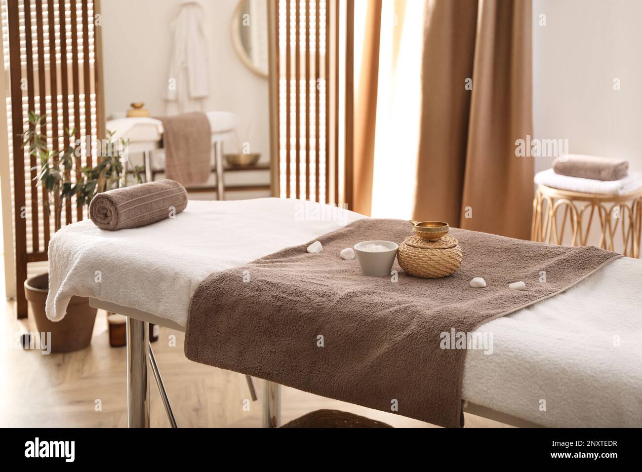 Stylish room interior with massage table in spa salon Stock Photo - Alamy