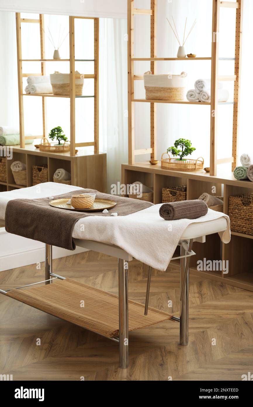 Stylish room interior with massage table in spa salon Stock Photo - Alamy