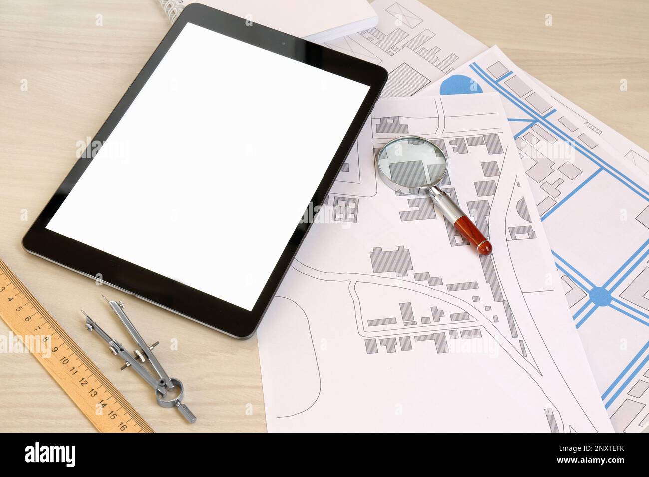 Office stationery, tablet and cadastral maps of territory with ...