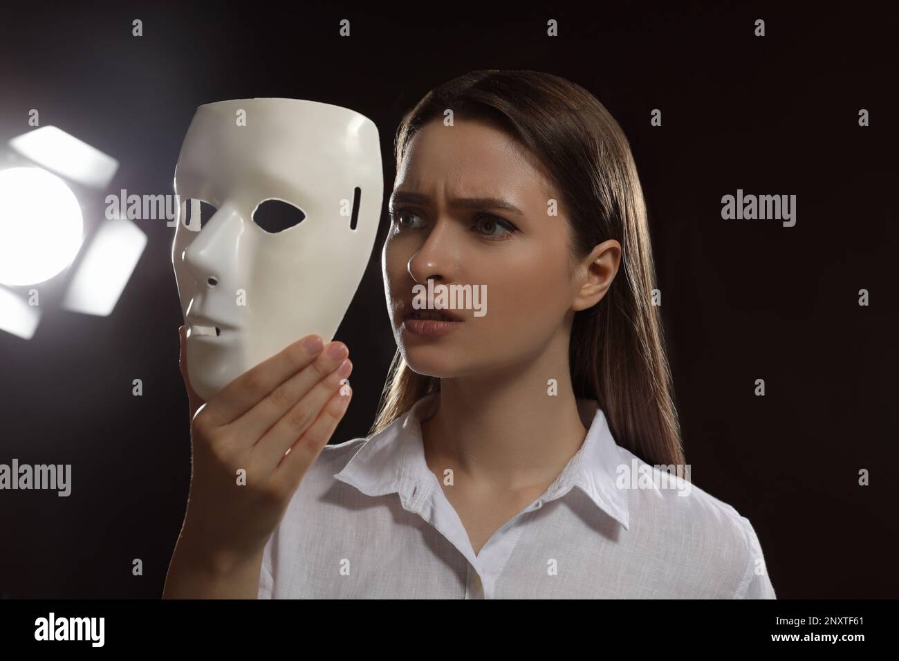 Professional actress with mask on stage in theatre Stock Photo - Alamy