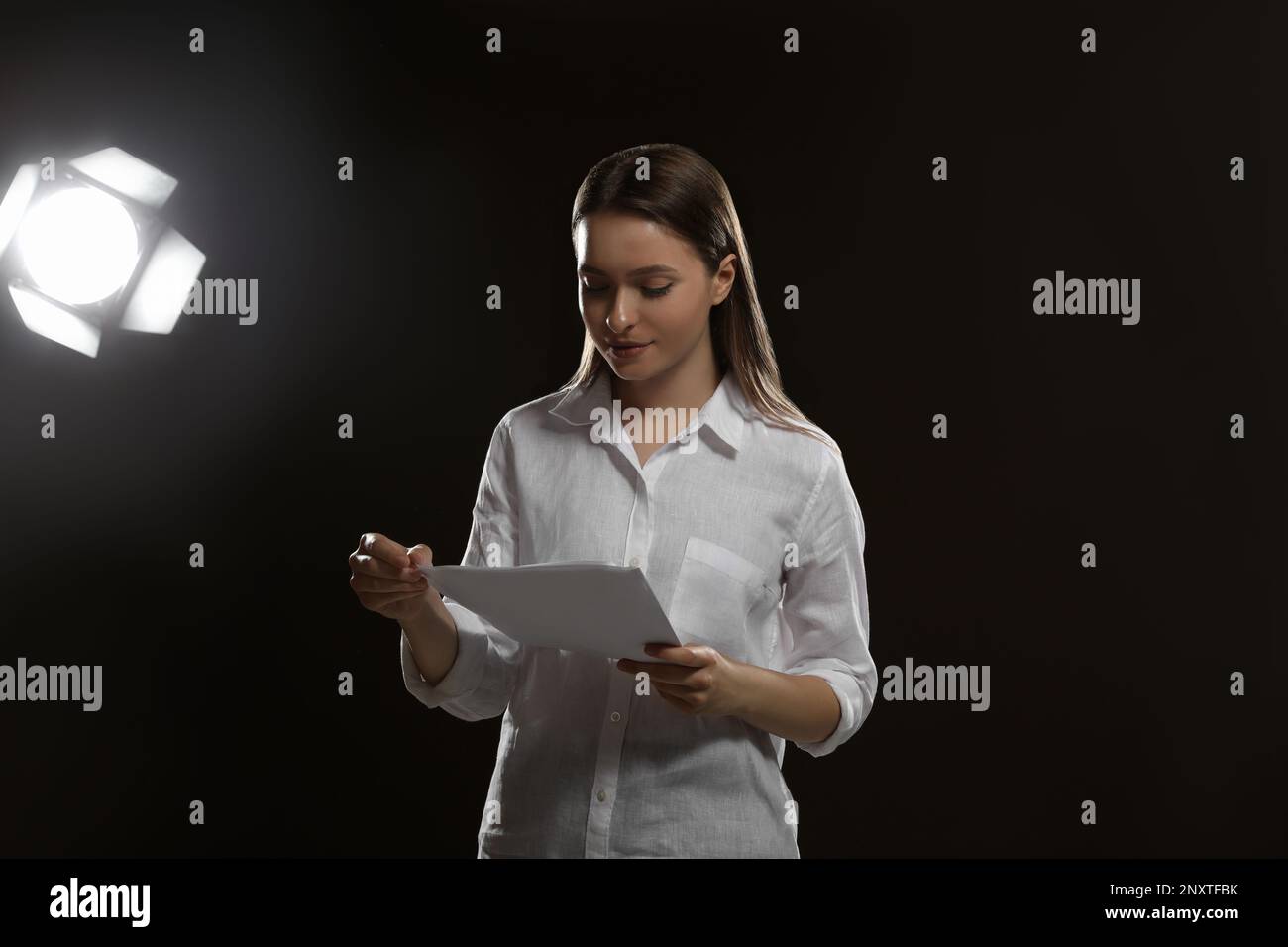Professional actress reading her script during rehearsal in theatre ...