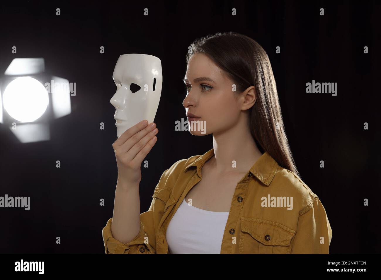 Professional actress rehearsing with mask on stage in theatre Stock ...