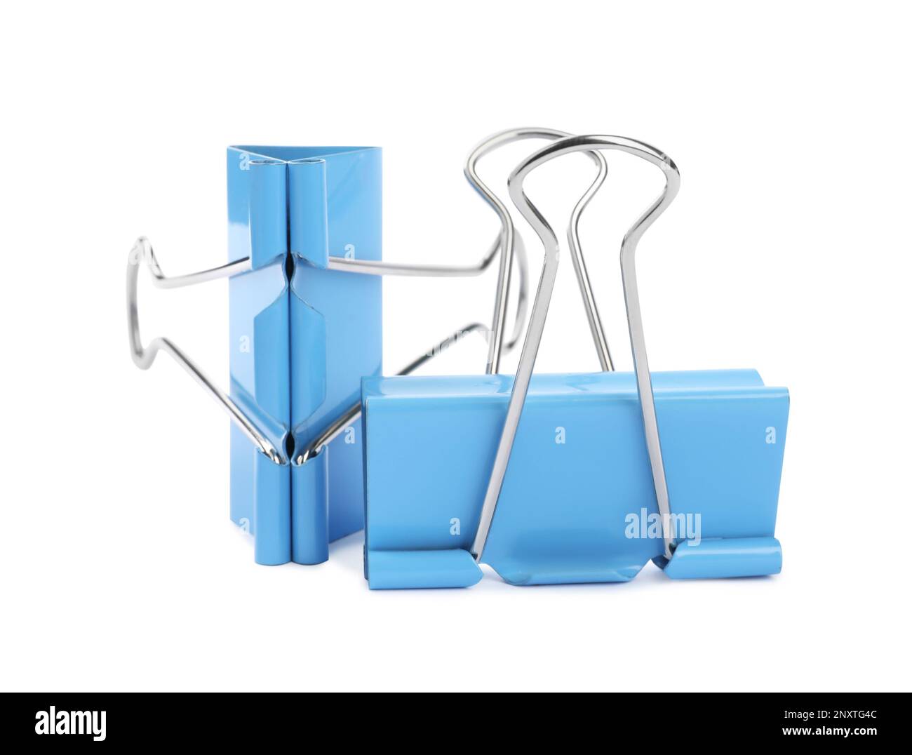 Light blue binder clips on white background. Stationery Stock Photo - Alamy