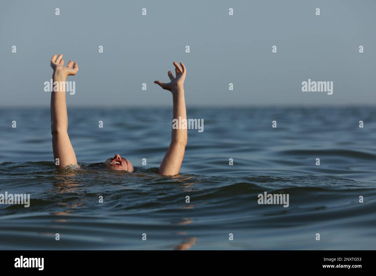 Drowning woman reaching for help in sea Stock Photo - Alamy
