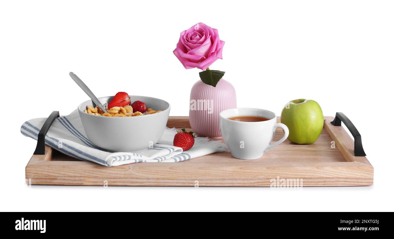 Wooden tray with delicious breakfast and beautiful flower on white ...