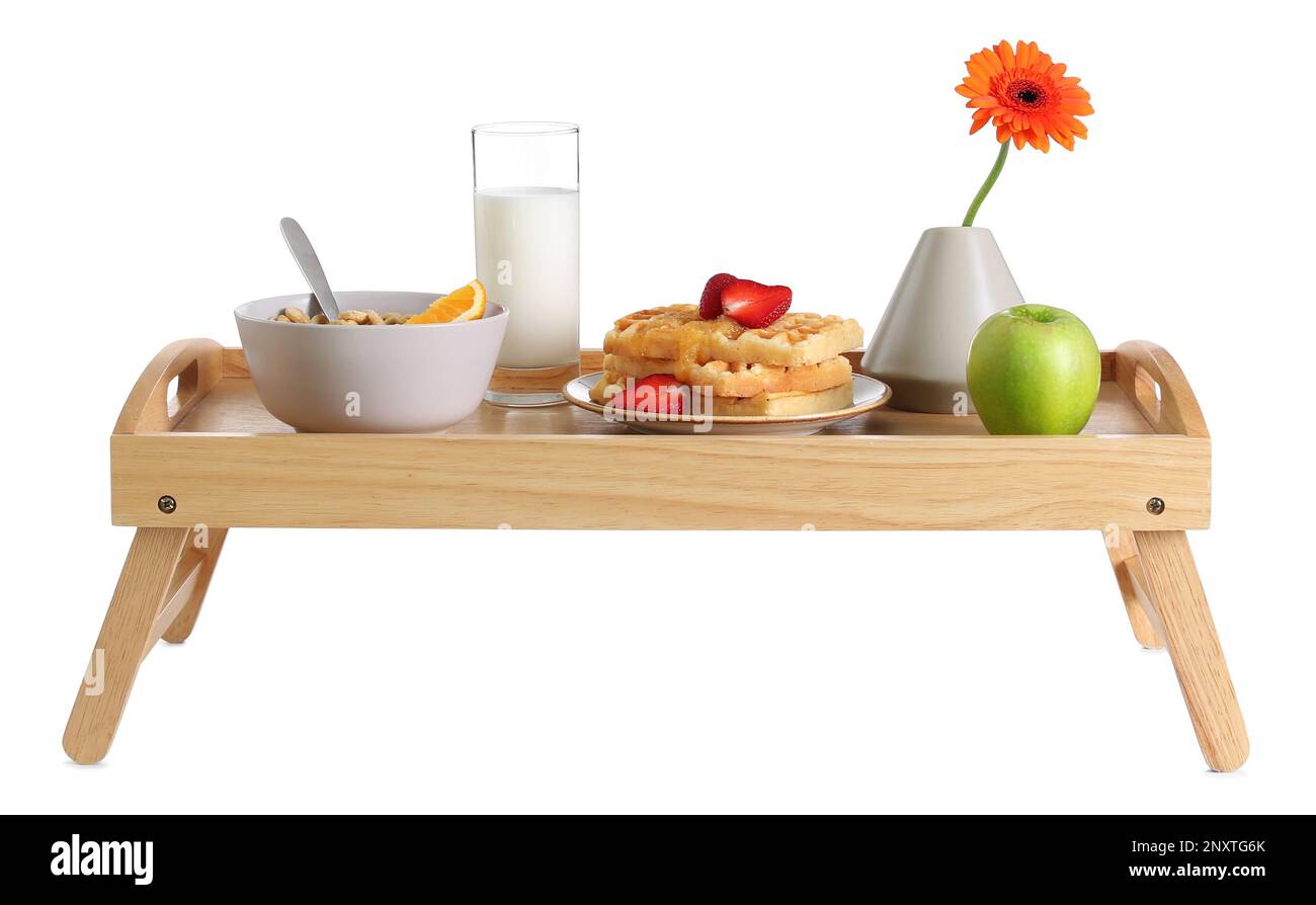 Wooden tray with delicious breakfast and beautiful flower on white ...