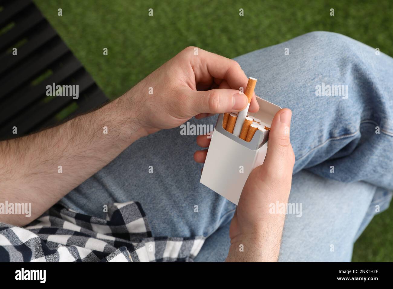 Man taking cigarette from pack outdoors, above view Stock Photo - Alamy
