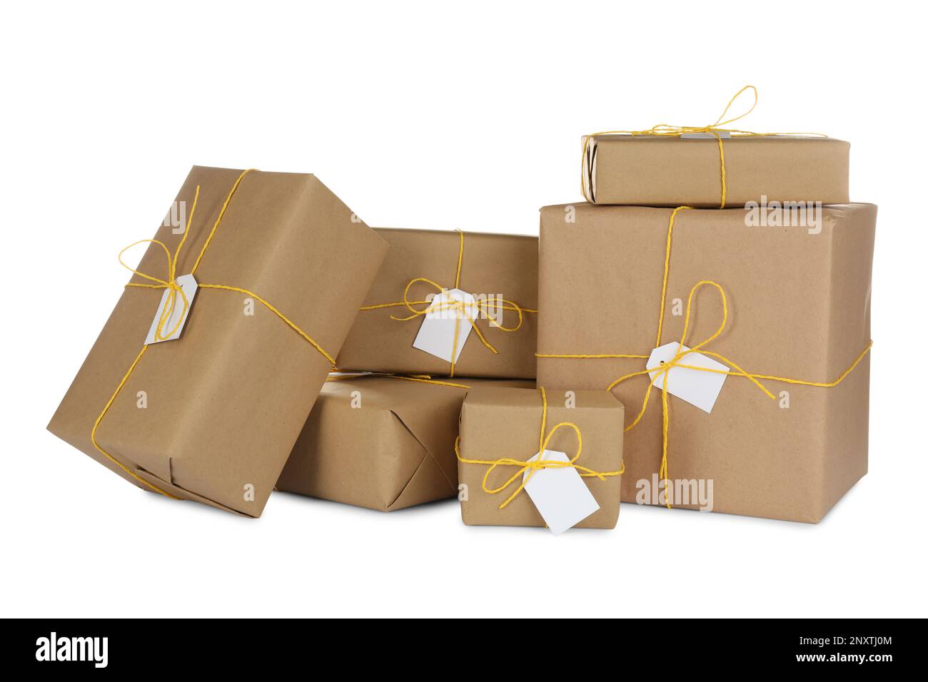 Parcels wrapped in kraft paper with tags on white background Stock ...