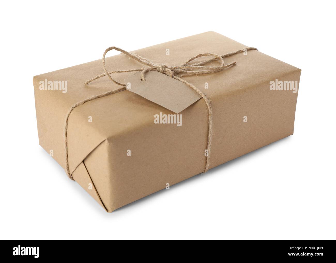 Parcel wrapped in kraft paper with tag on white background Stock Photo ...