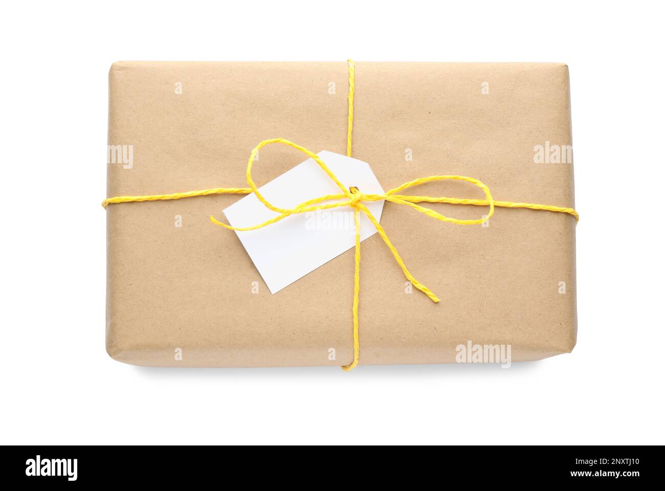 Parcel wrapped in kraft paper with tag on white background, top view ...