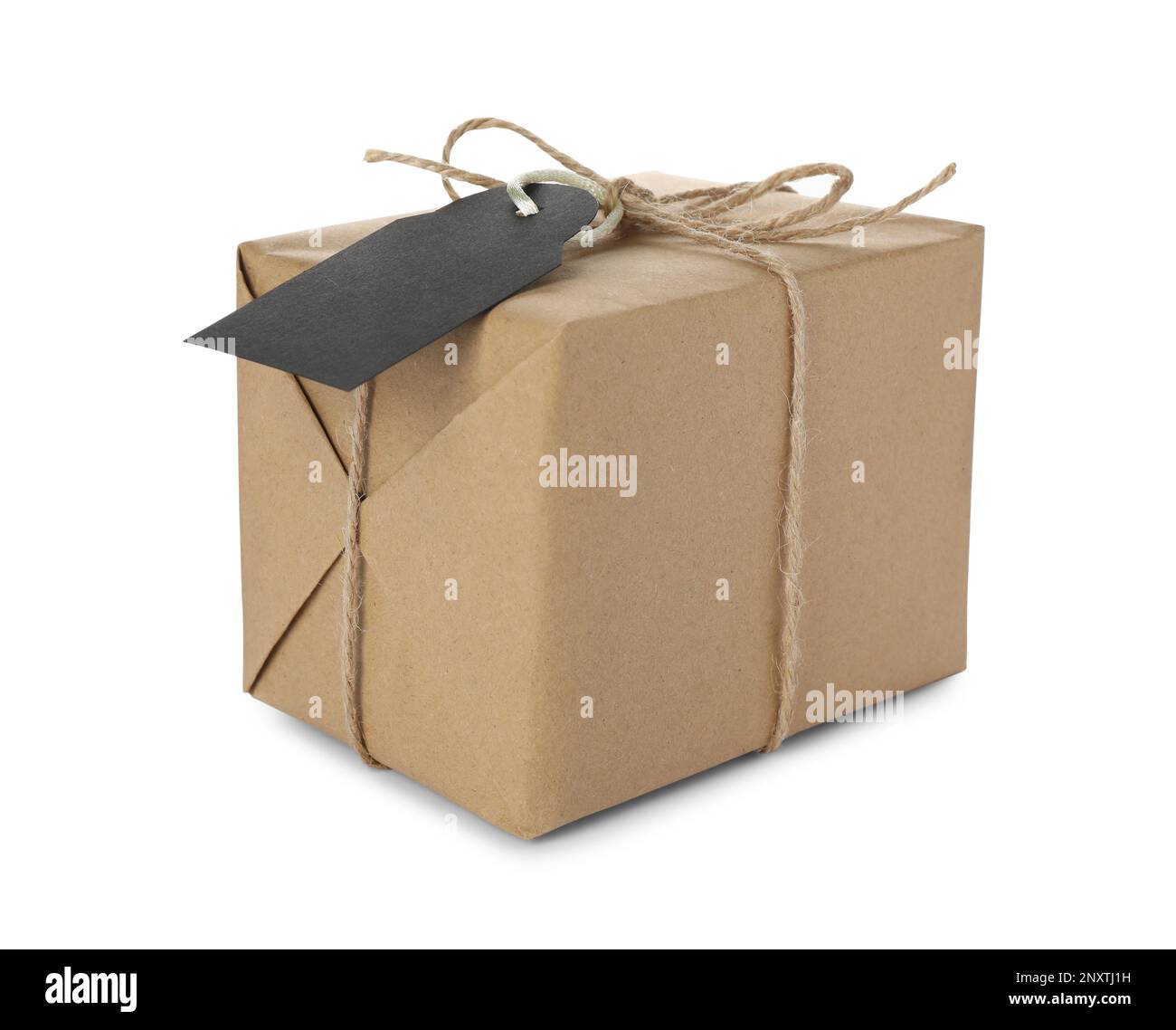 Parcel wrapped in kraft paper with tag on white background Stock Photo ...