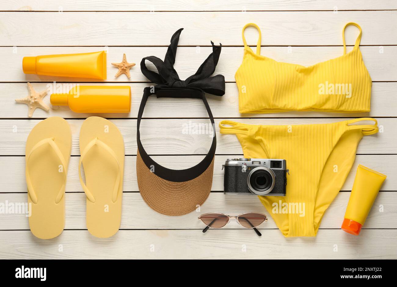 Flat lay composition with beach objects on white wooden background ...