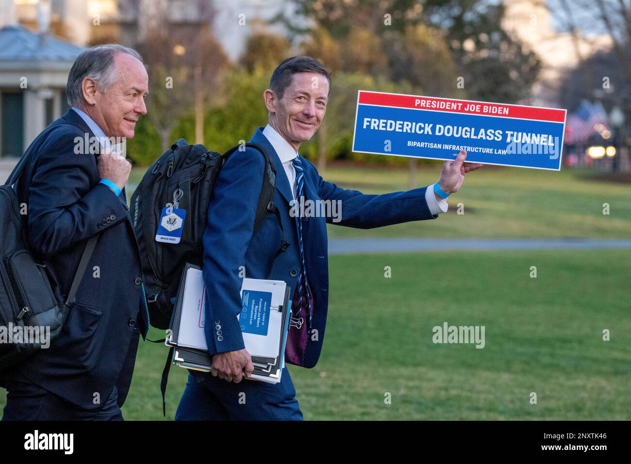 White House deputy chief of staff Bruce Reed, right, carries a sign as ...