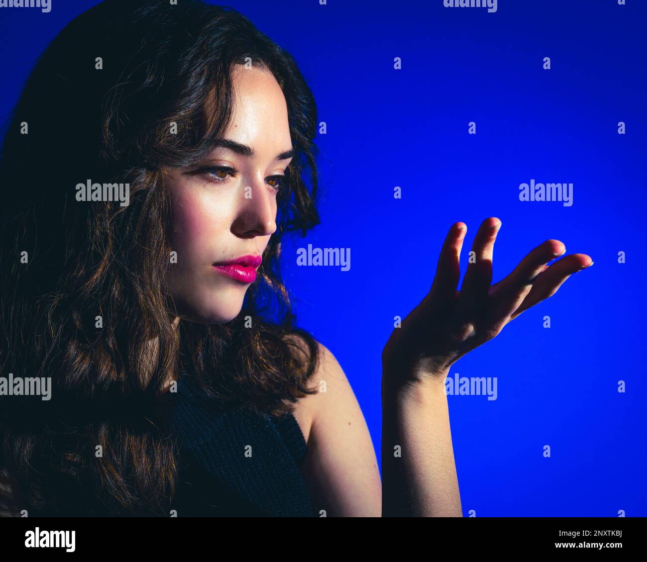 Close Up Side View of Beautiful Young Woman in Profile Against Blue ...