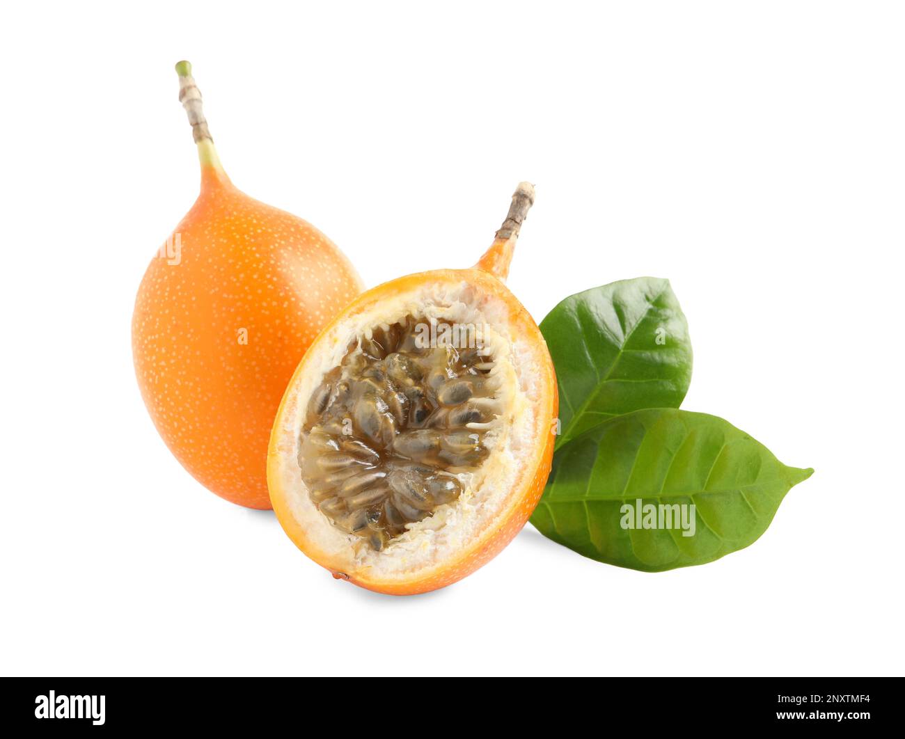 Whole and cut delicious ripe granadillas with green leaves on white ...