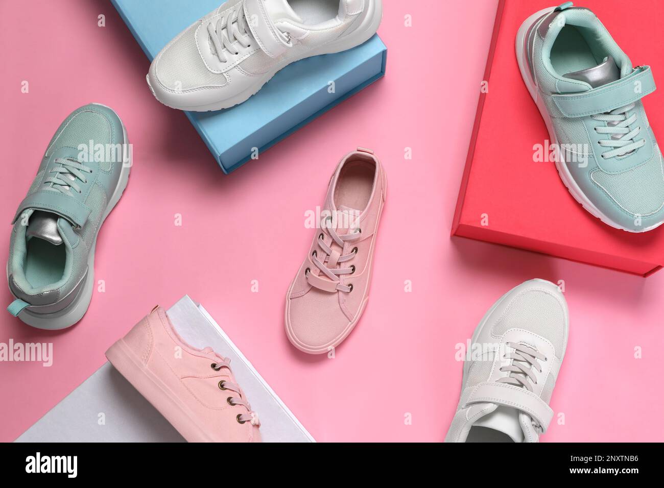 Flat lay composition with different stylish sports shoes on pink ...