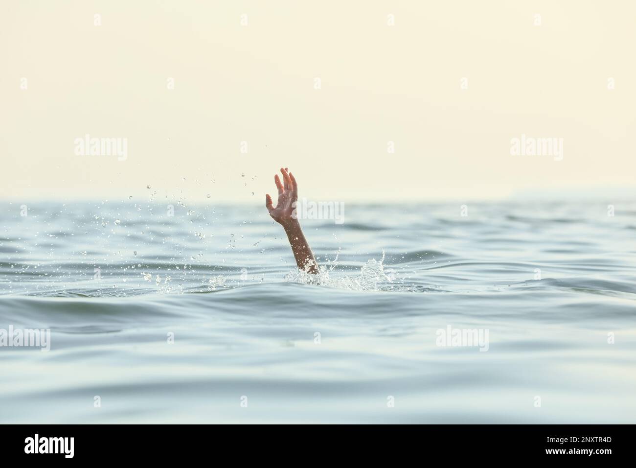Drowning woman reaching for help in sea Stock Photo - Alamy