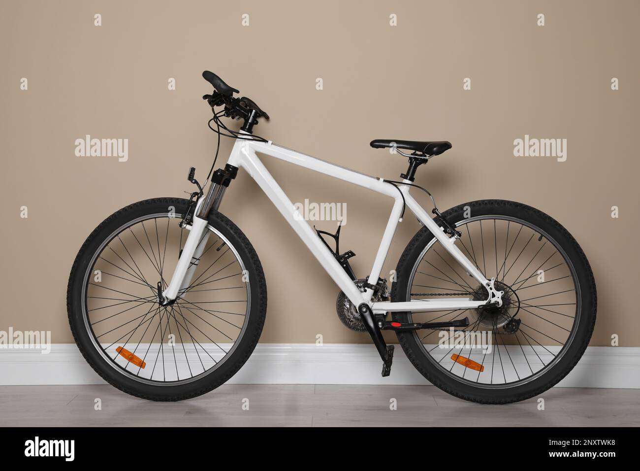 Modern sport mountain bike near beige wall Stock Photo - Alamy