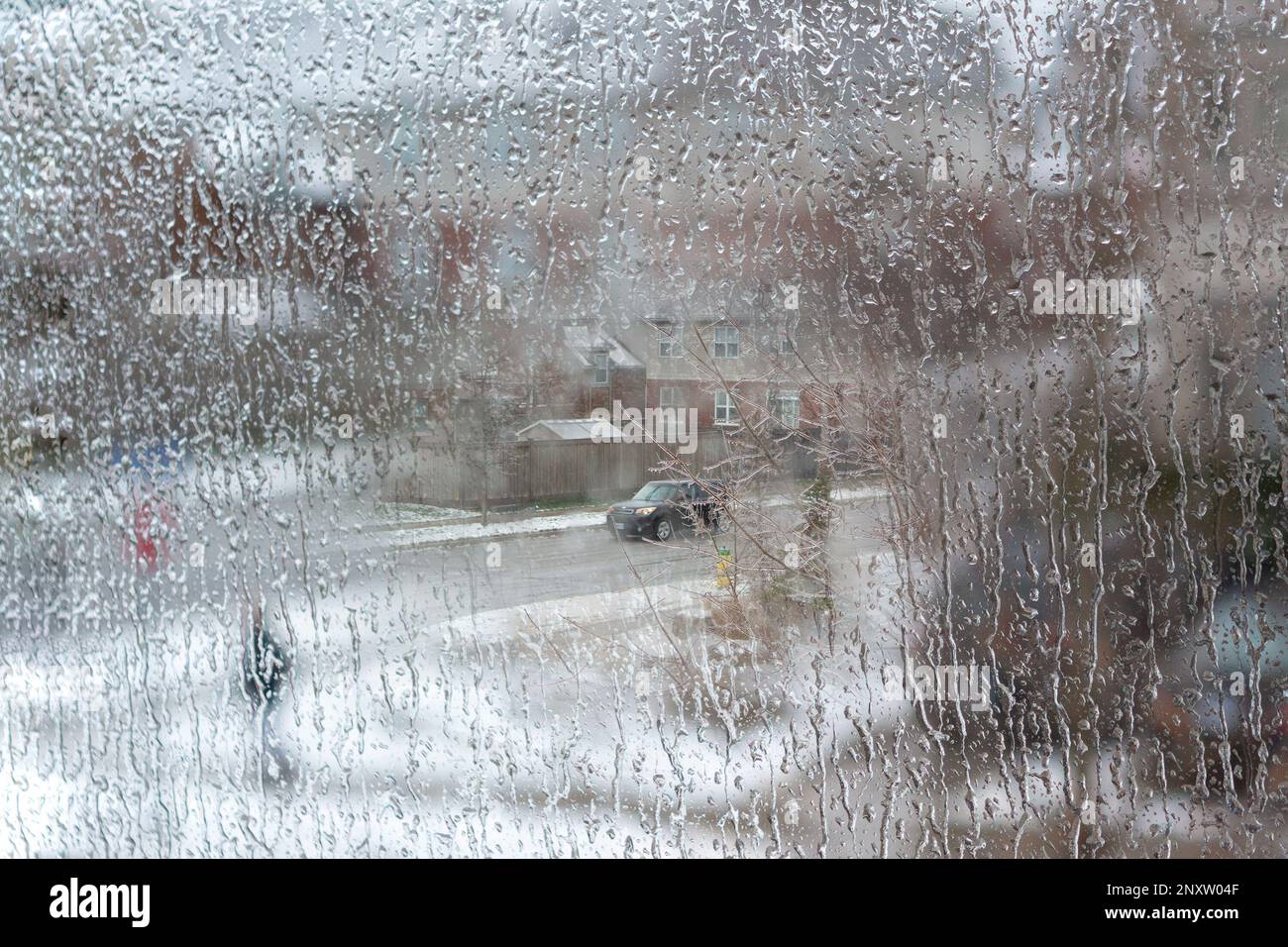A winter storm caused rain and snow to draw a pattern on the window ...