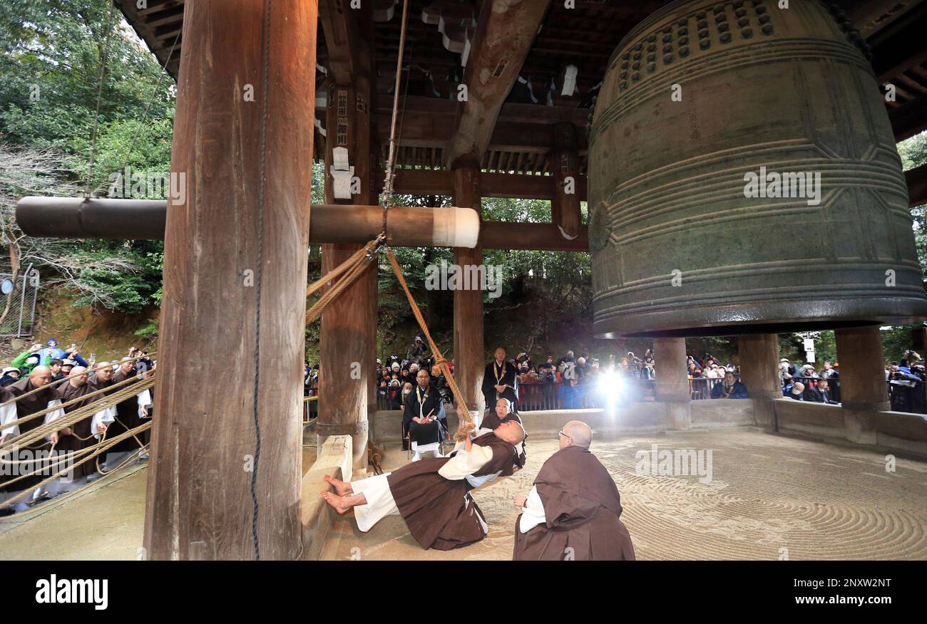 Buddhist monks use a rope to toll a giant New Year's Eve bell at Chion ...