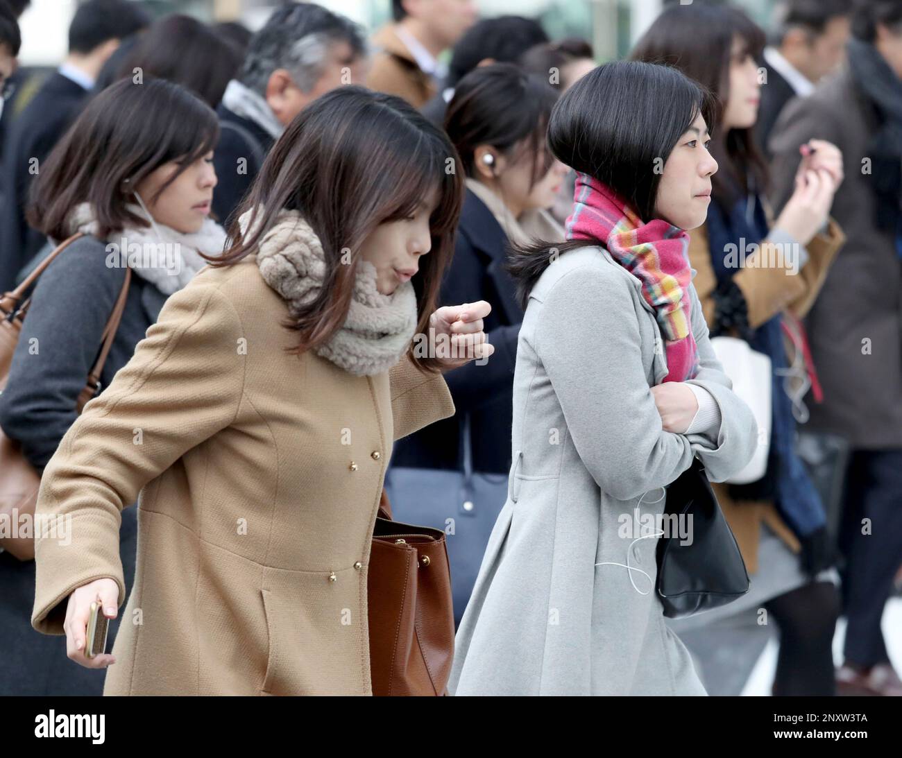 People wearing thick clothes according to cold weather head for offices ...