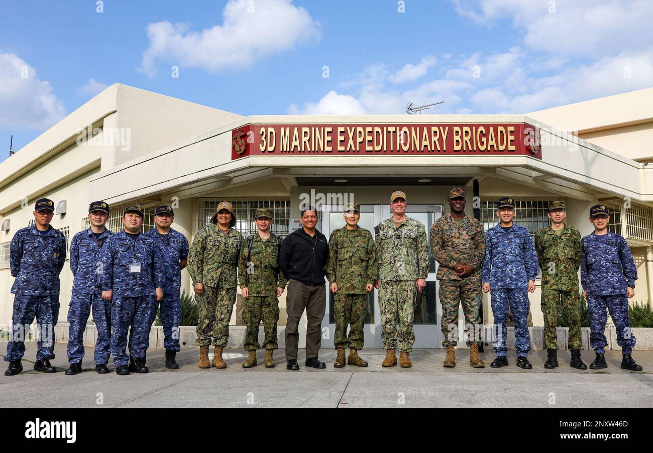 U.S. Marines and Sailors from Task Force 76/3 pose for a photo with ...