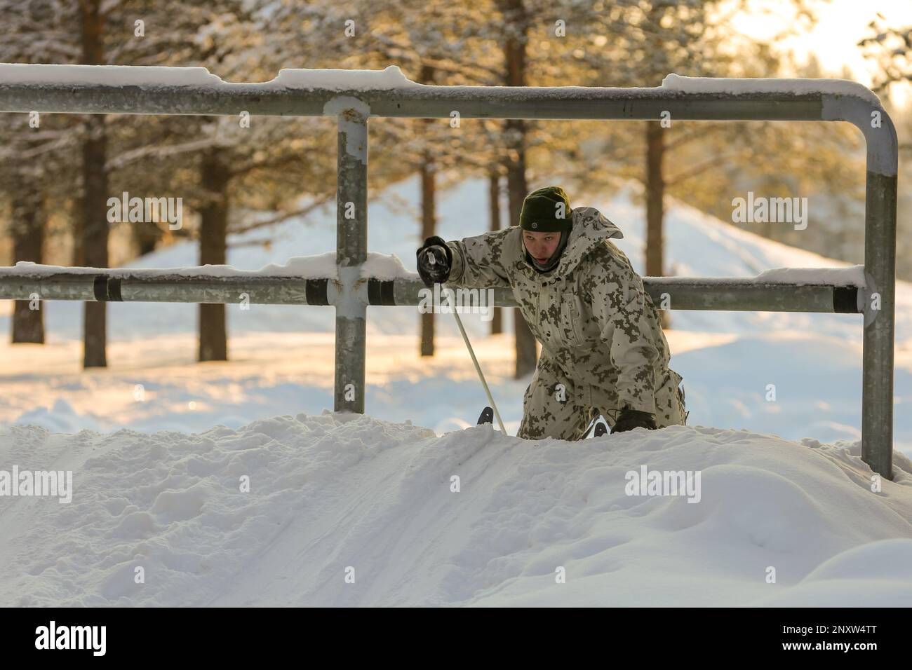 A Finnish army soldiers progresses through the ski obstacle course ...