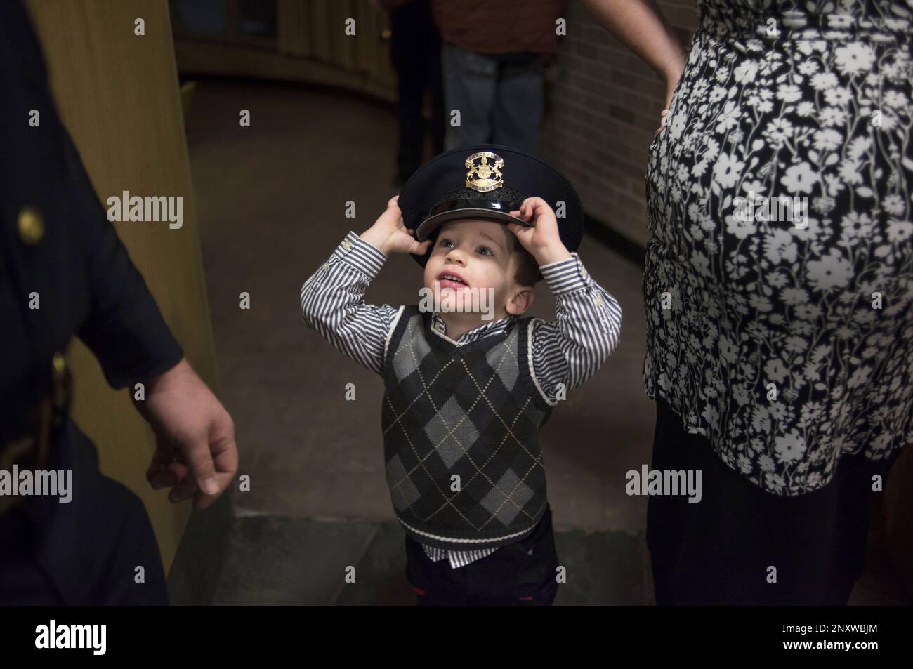 Wayne Kooi, 2, center, looks up at his dad Flint reserve officer ...