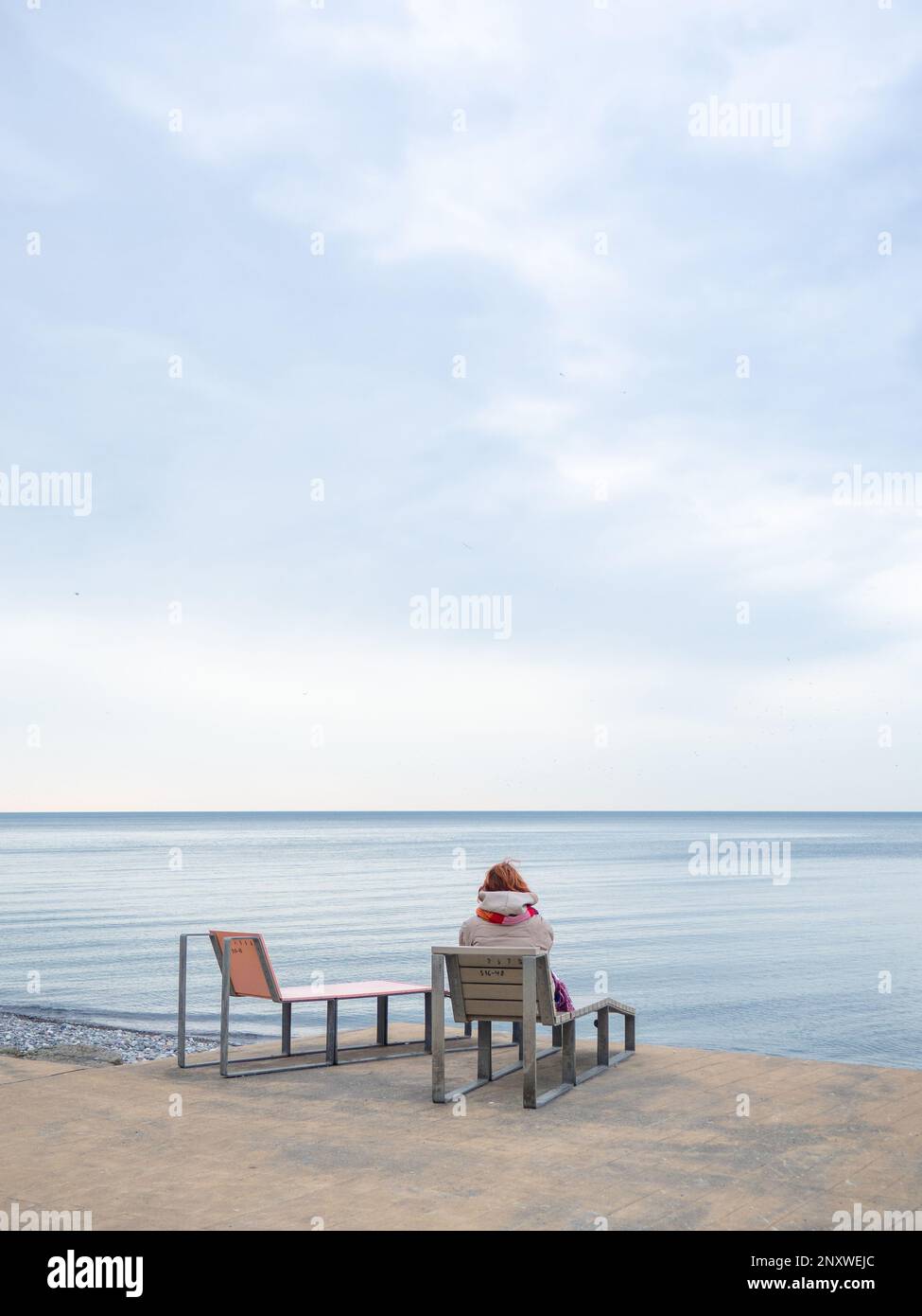 Benches for lying by the sea. Sun loungers in the park against the ...