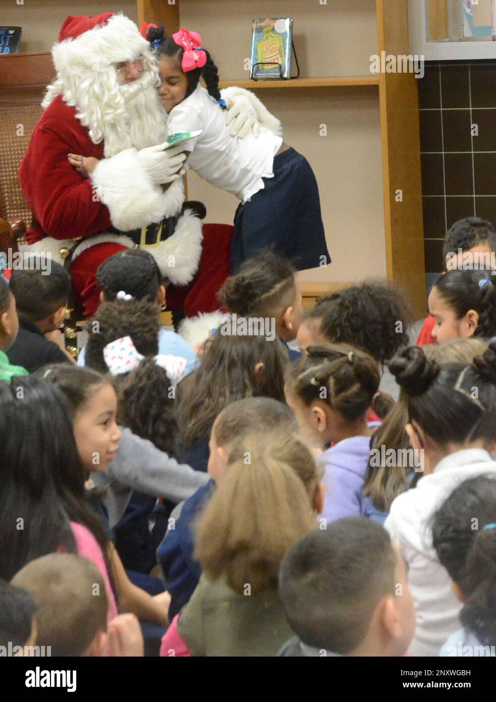 Santa Claus gets a big hug from a 1st grade student at Heights-Terrace ...