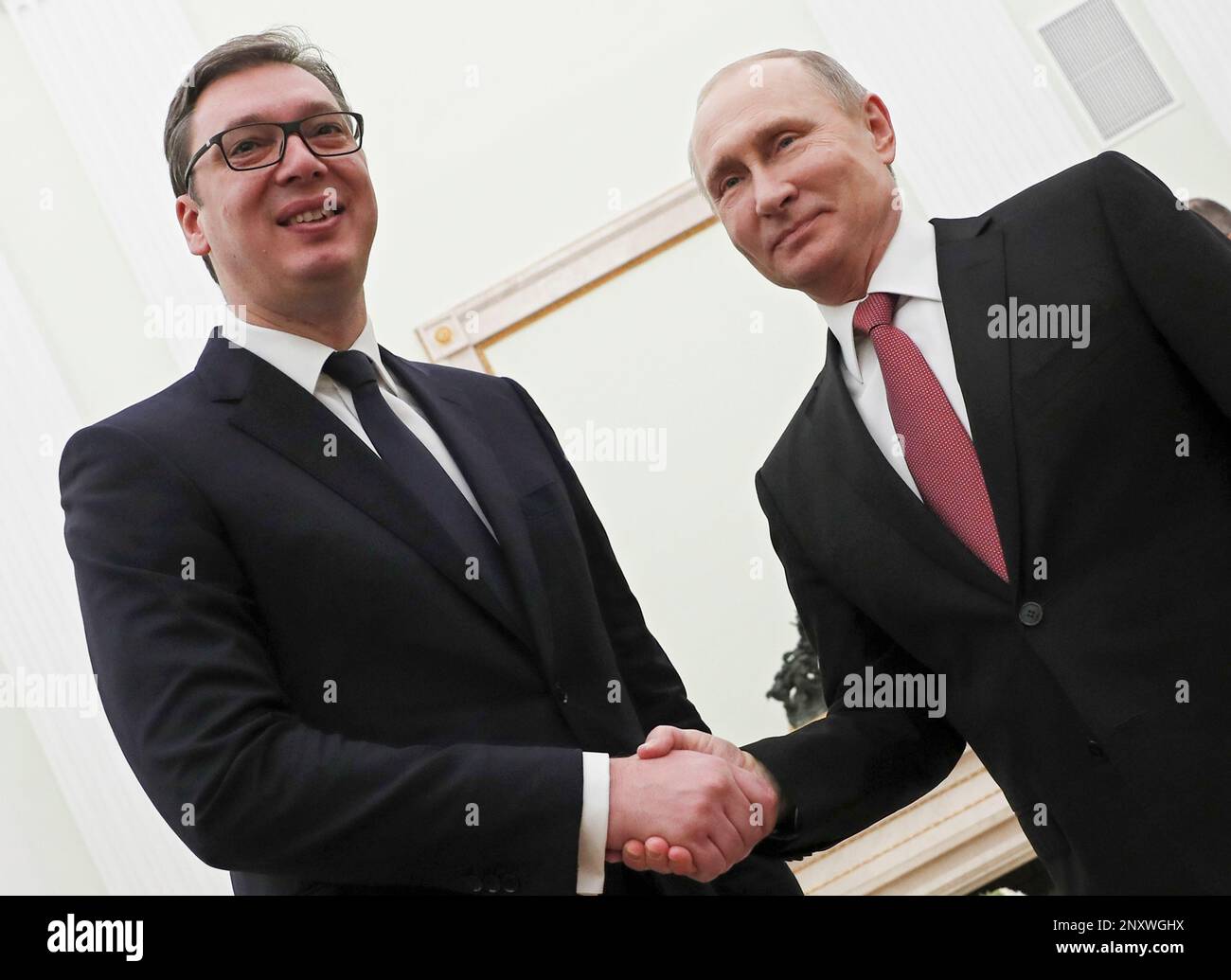 Russian President Vladimir Putin, right, shakes hands with Serbian ...