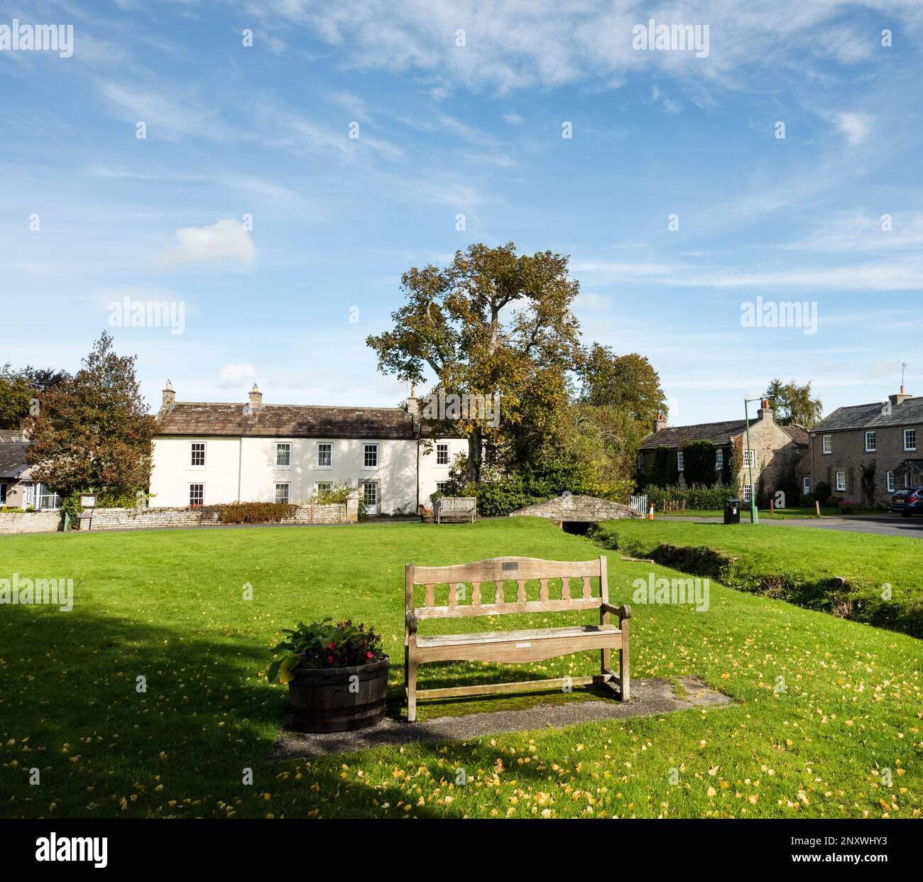 The village green Cotherstone with a menmorial bench, tiny stone bridge ...