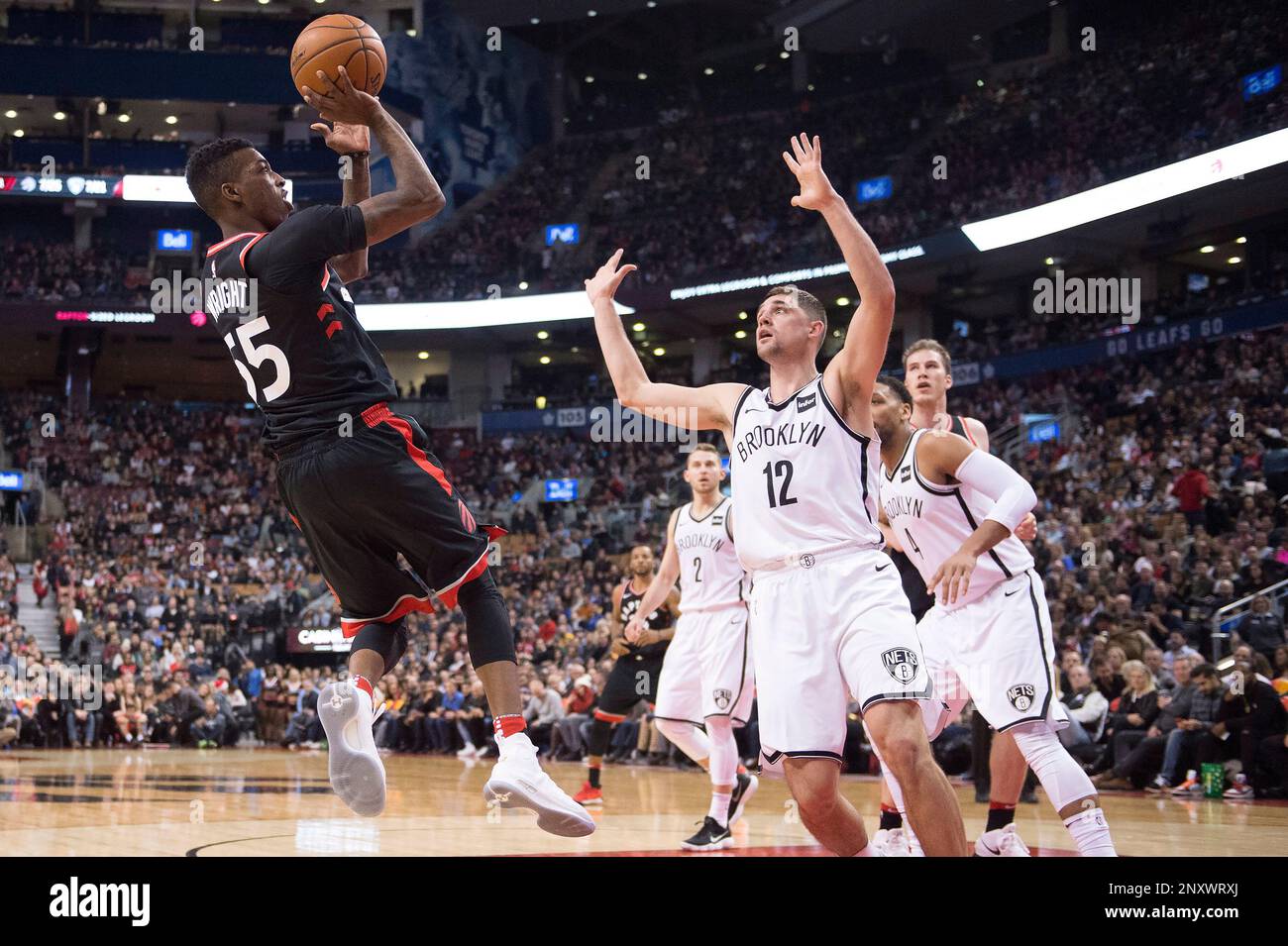 Toronto Raptors guard Delon Wright (55) scores past Brooklyn Nets guard ...