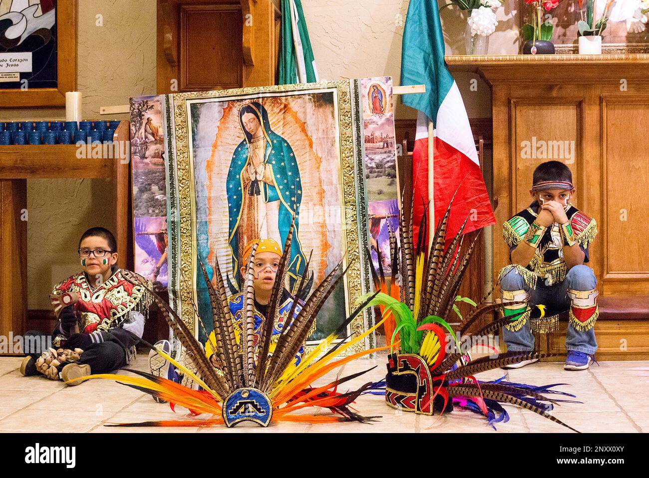 Young Matachina dancers sit during Día de la Virgen de Guadalupe feast ...