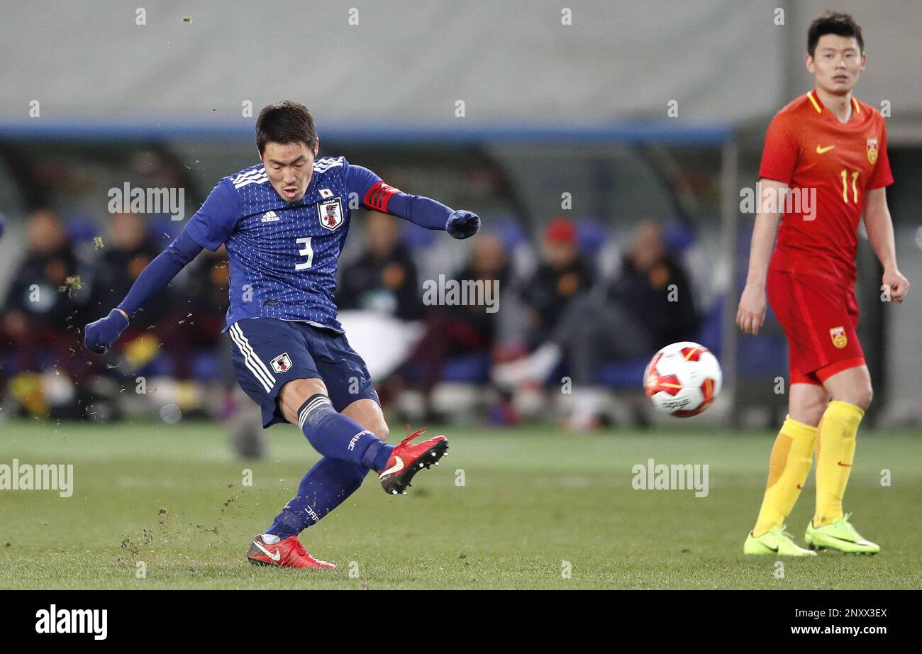 Japan's Gen Shoji, left, scores a goal against China in their soccer ...