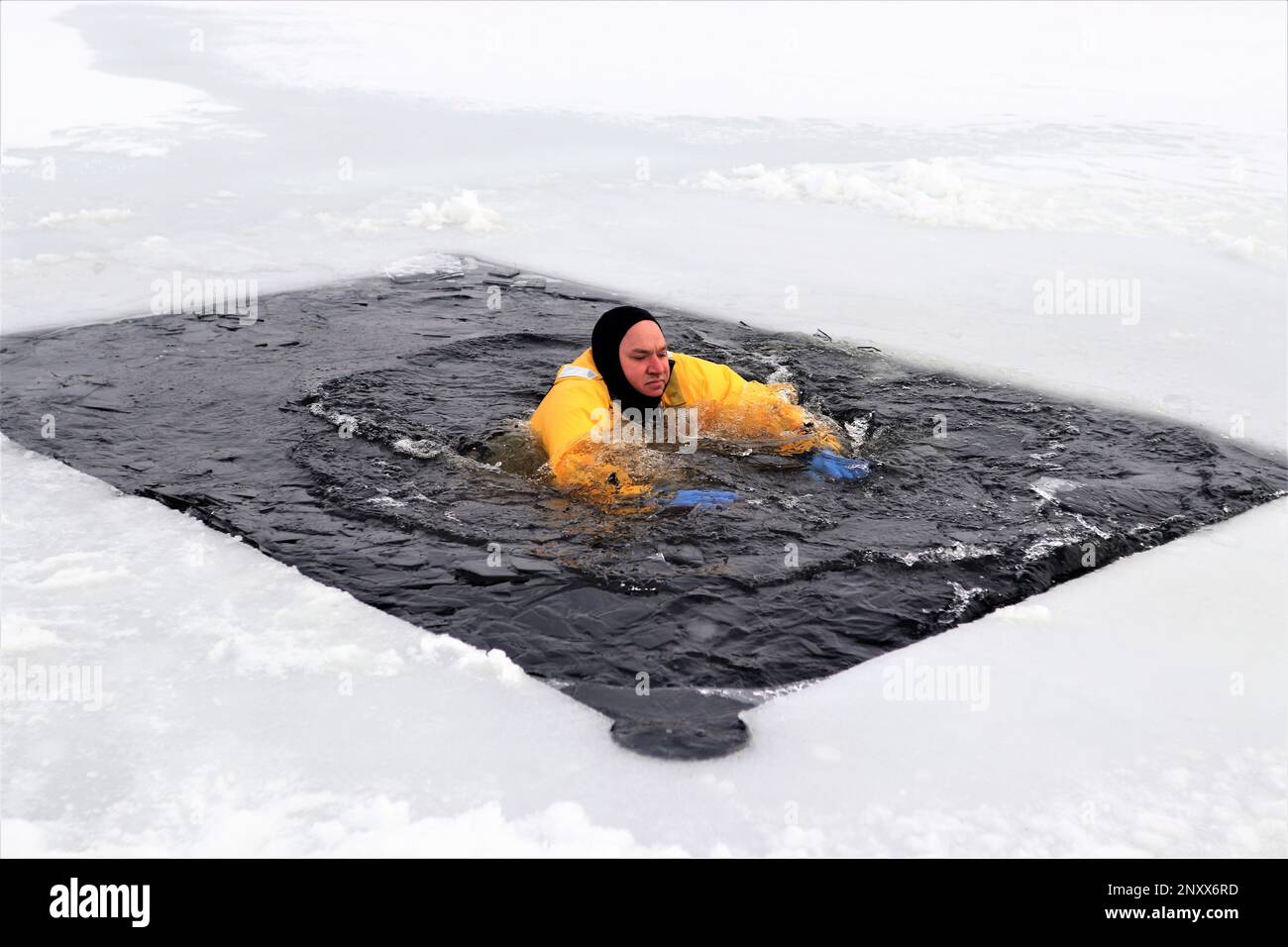 A firefighter wearing a cold-water immersion protective suit acts as a ...