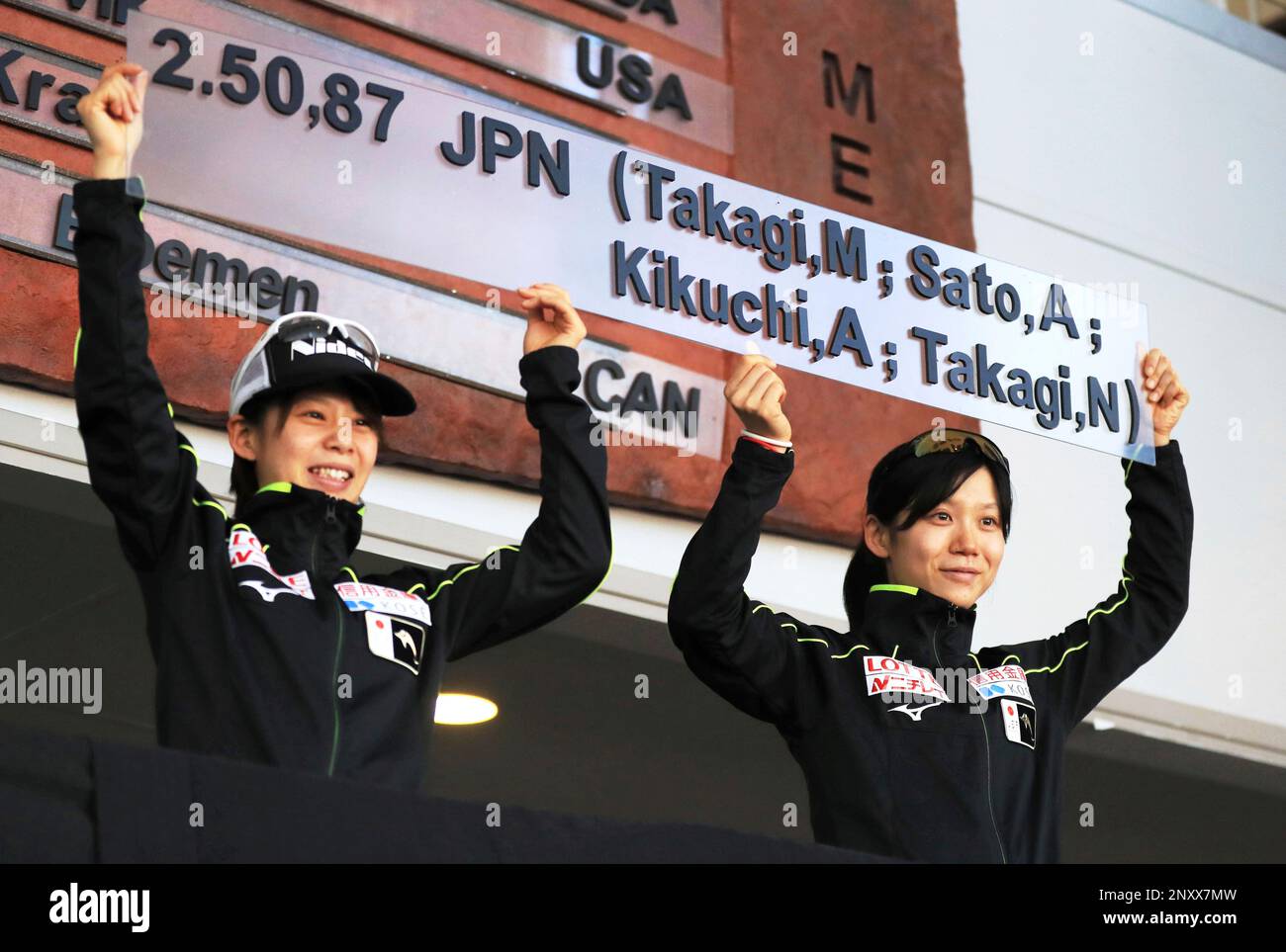 Japan's Nana Takagi(L) and Miho Takagi hold a plate that shows their names and the time of Team ...