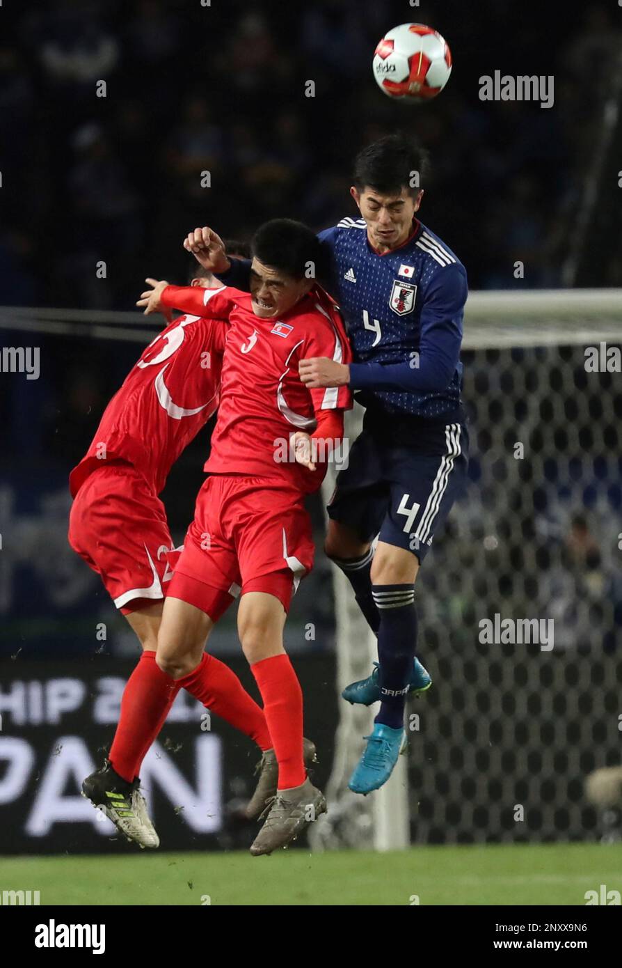 Japan's Shogo Taniguchi(L) and Ntorh Korea's Un Chol Ri straggle a ball ...