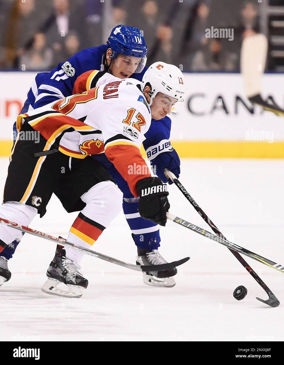 Calgary Flames left wing Johnny Gaudreau (13) and Toronto Maple Leafs ...