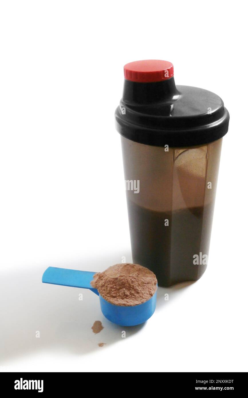 Close-up on a protein shaker and a scoop of whey isolated on white ...
