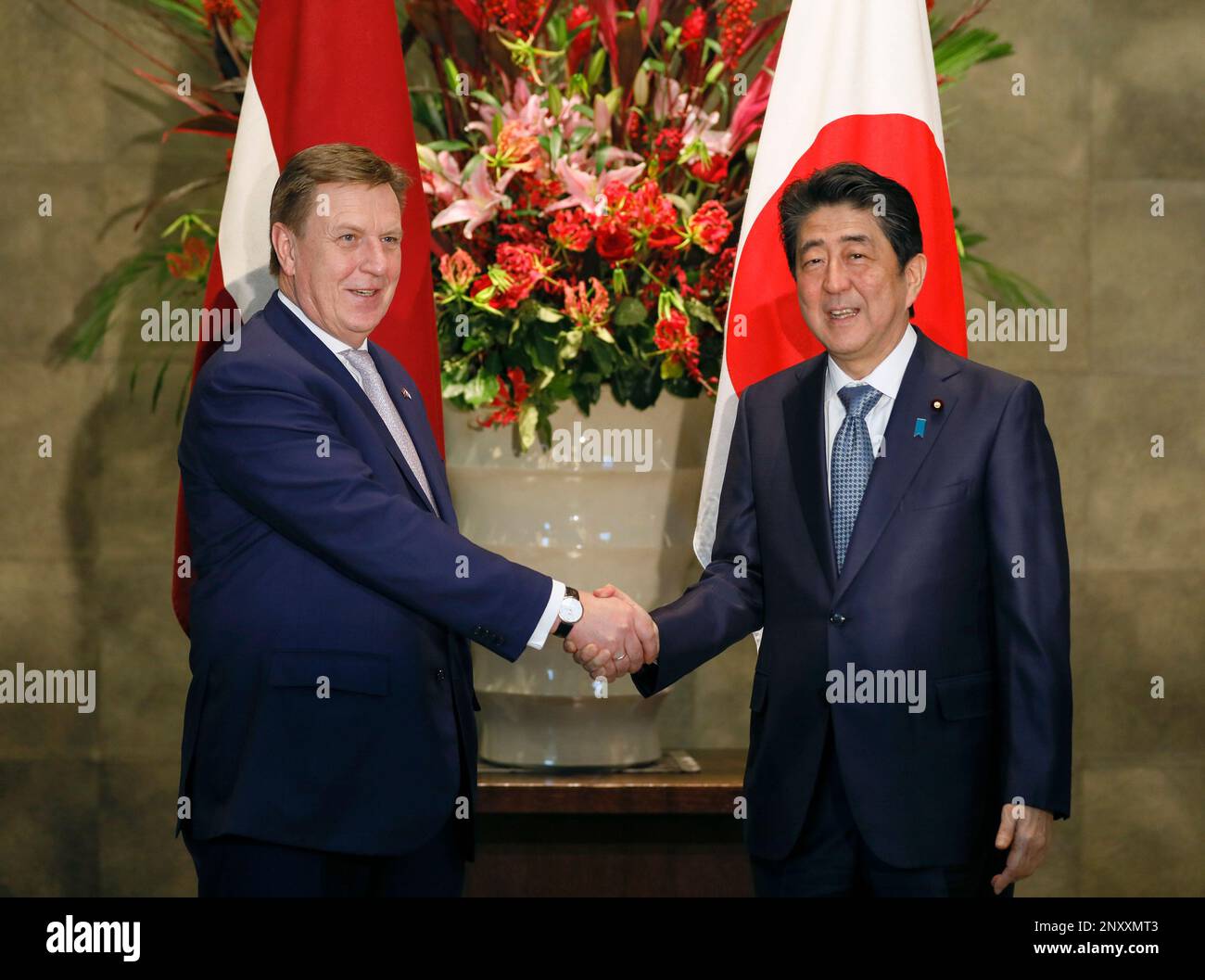 Latvian Prime Minister Maris Kucinskis, left, shakes hands with ...