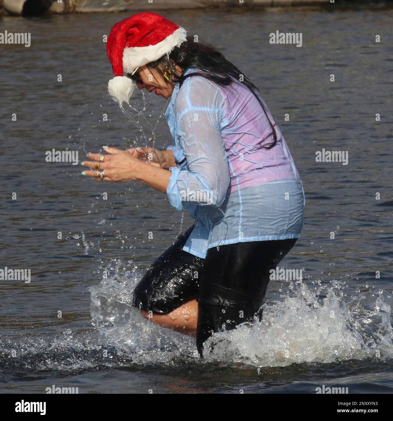 Connie Cramer races to get out of the cold water of Harveys Lake during ...